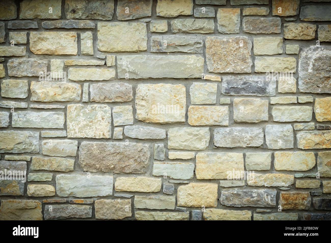 Solid yellow and beige stone wall with vignette, good for background ...