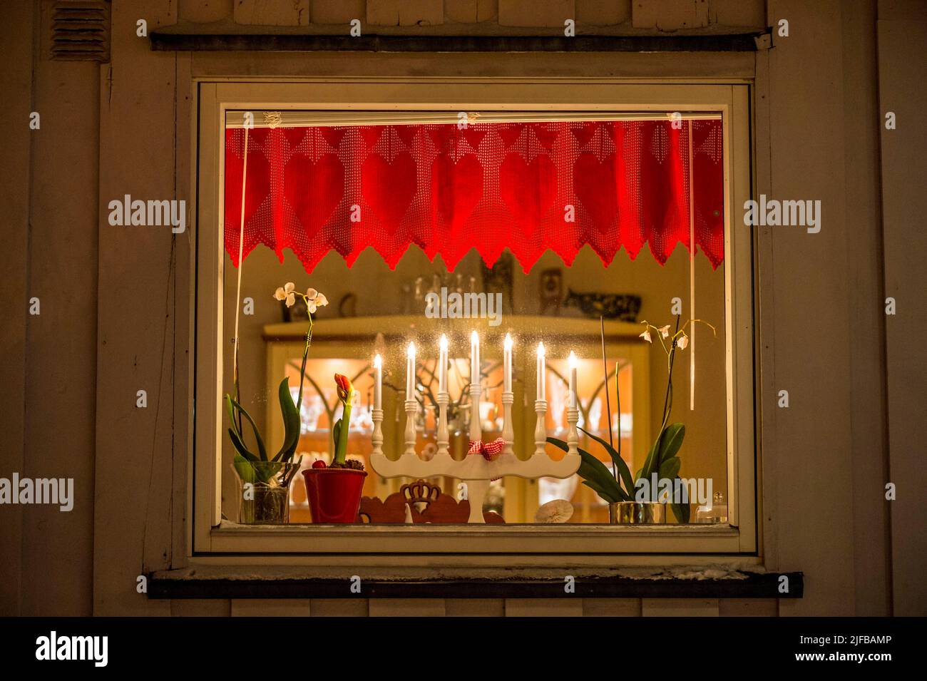 Norway, Lapland, County of Finnmark, Kirkenes, window illuminated with ...