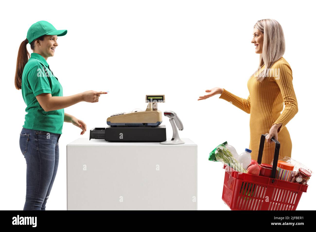 Customer at a cash register with a shopping basket isolated on white ...