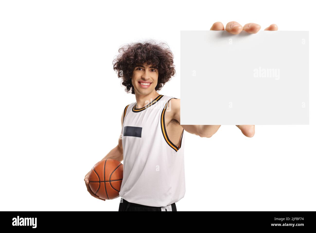 Basketball player holding a ball and showing a blank card isolated on ...