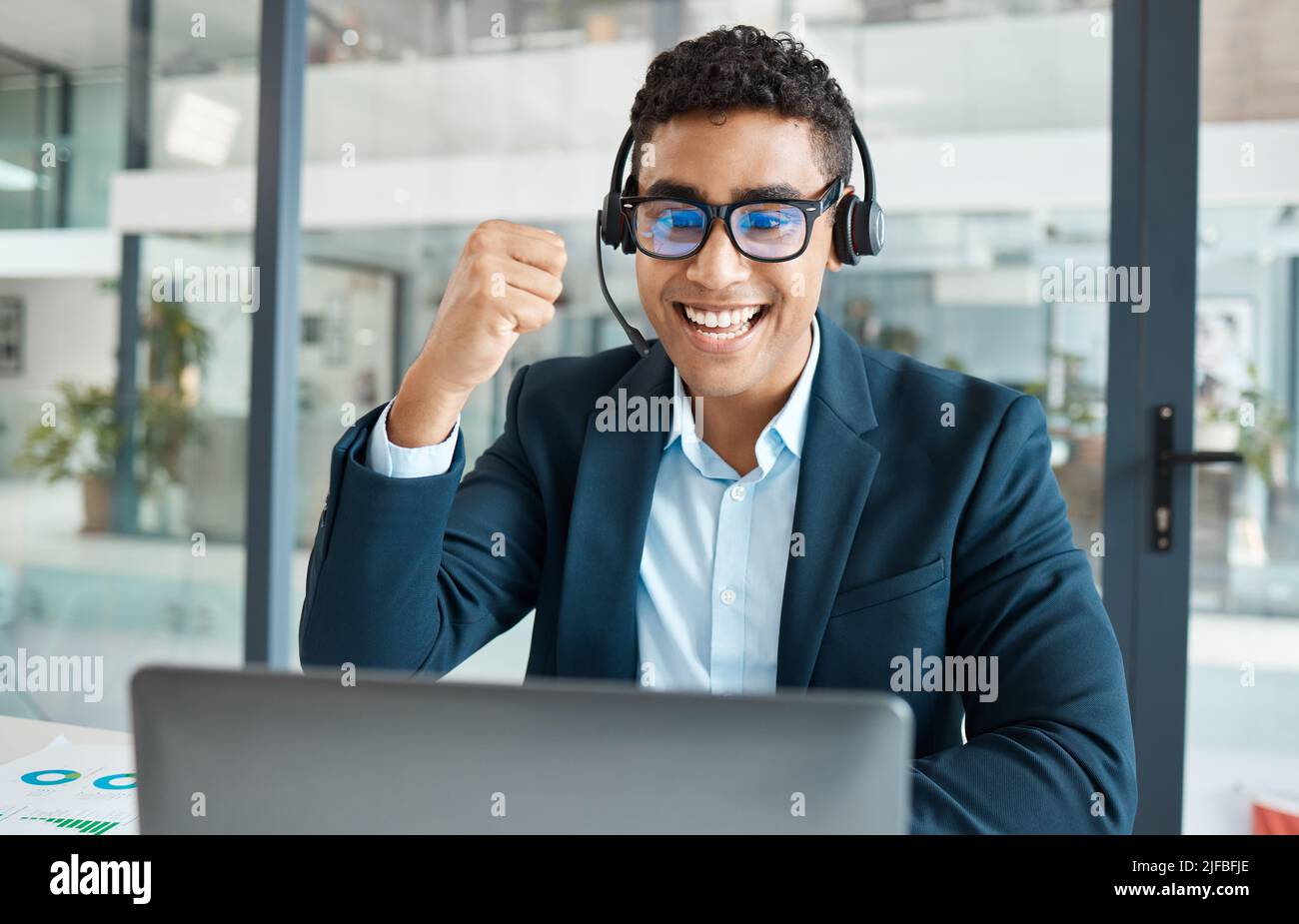 Young happy mixed race male call center agent answering calls while ...