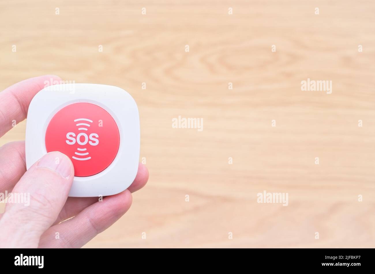 person holding device with red SOS button - help request and danger ...