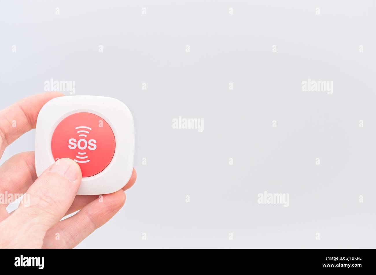 person holding device with red SOS button - help request and danger ...