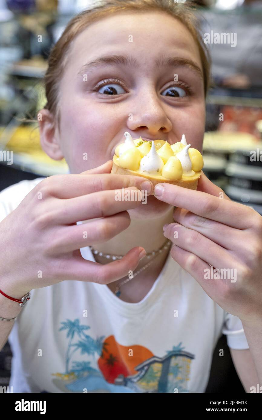 France, Paris, Maison Béchu, young girl tasting pastries, lemon tartlet ...
