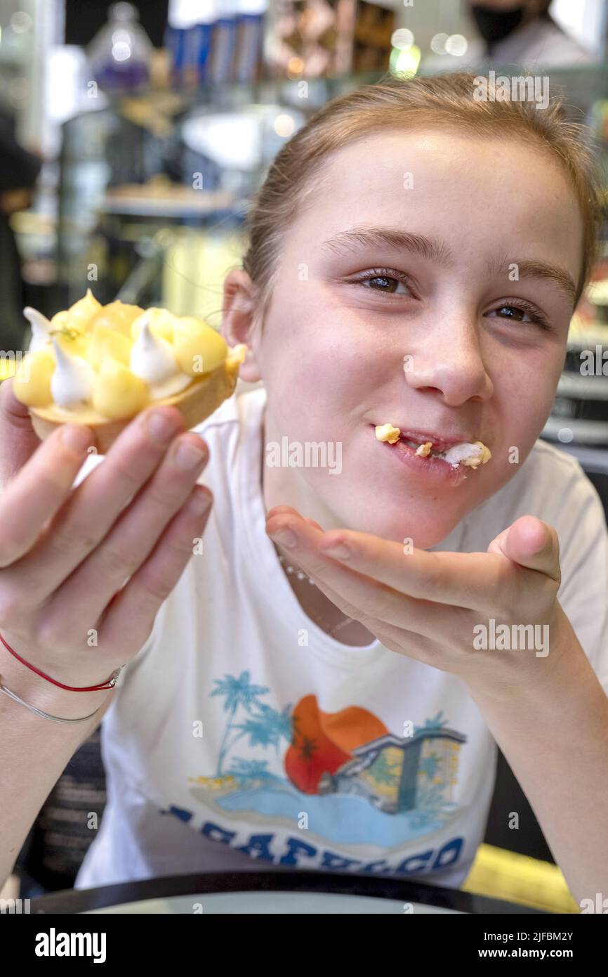 France, Paris, Maison Béchu, young girl tasting pastries, lemon tartlet ...