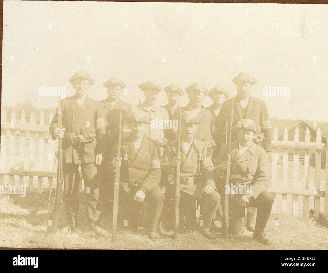 Men in landstorm uniform set up with rifles in front of the fence in ...