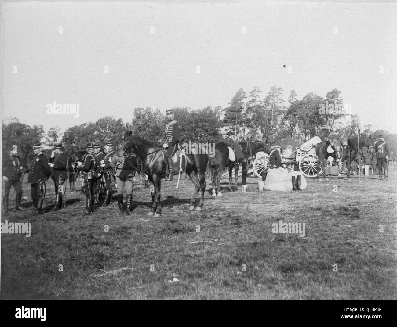Husars from unknown regiment in bivack. In the background loaded ...