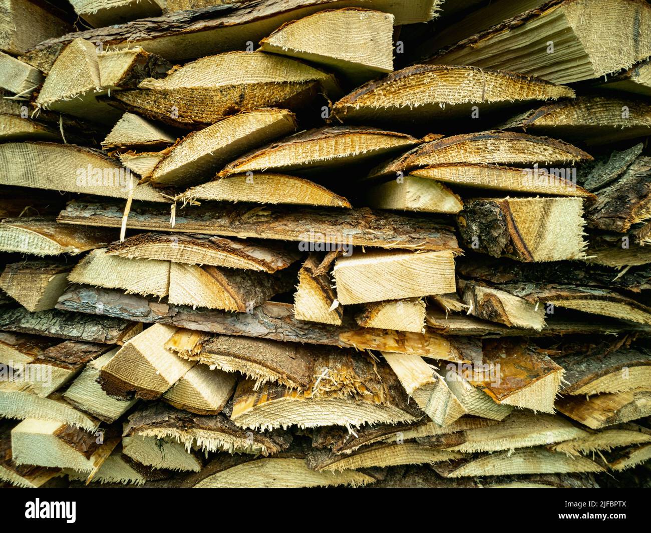 Wooden background. Chopped firewood for heating Stock Photo - Alamy