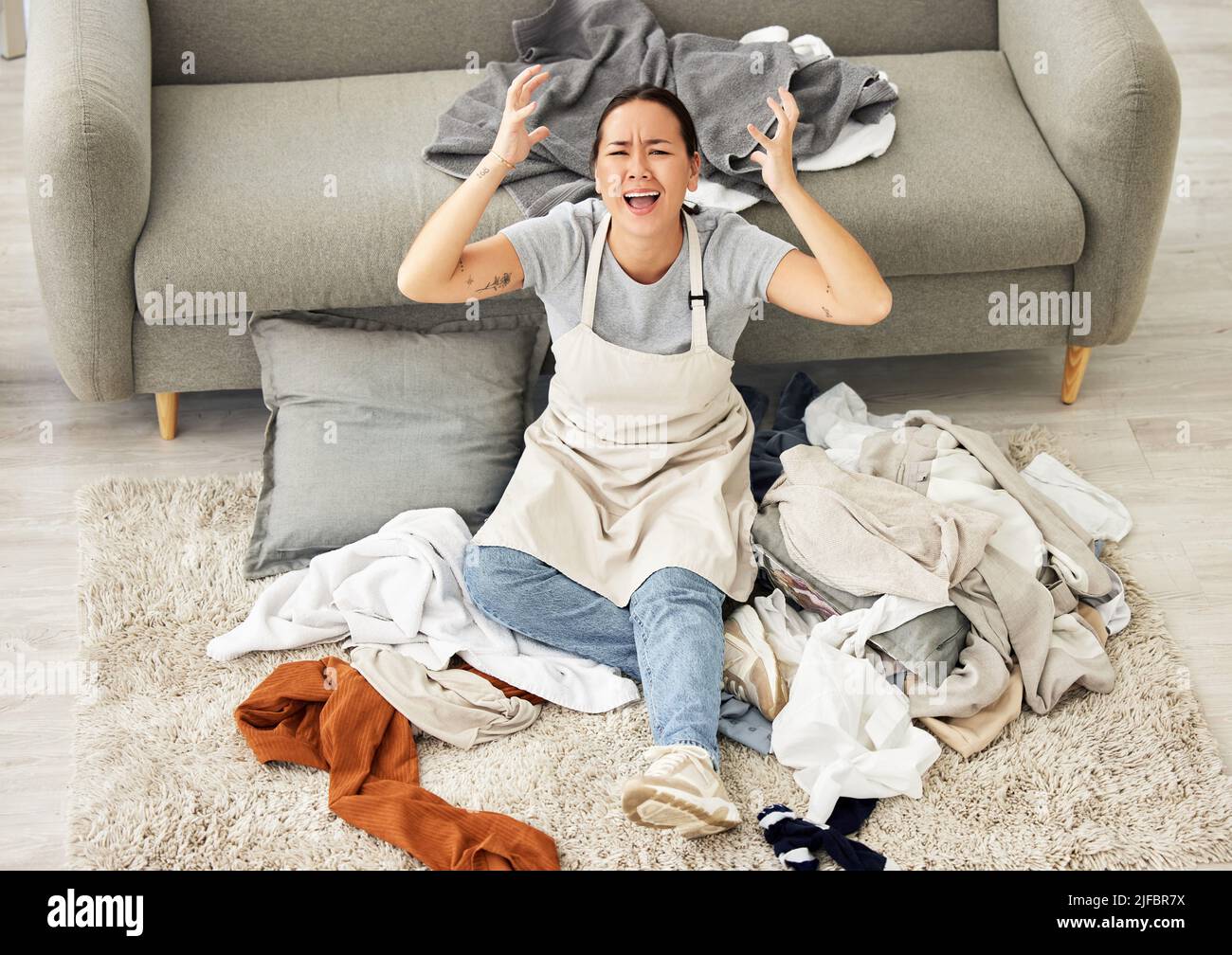 One woman overwhelmed pile of clothes hi-res stock photography and ...