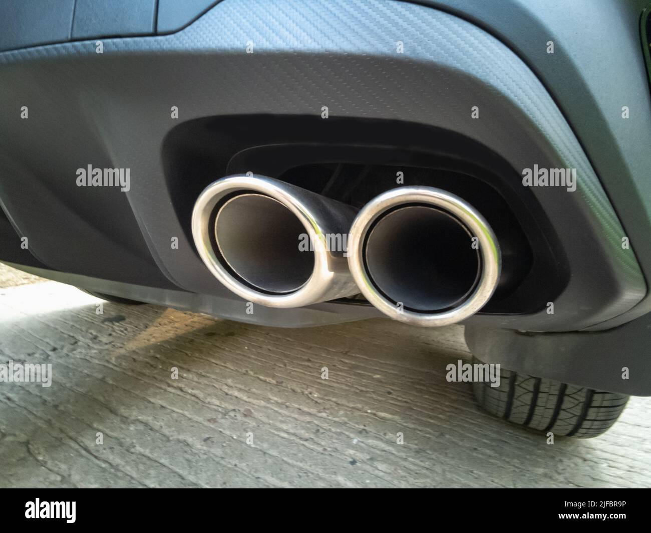 Pipes of the dual exhaust system of a car close-up Stock Photo - Alamy