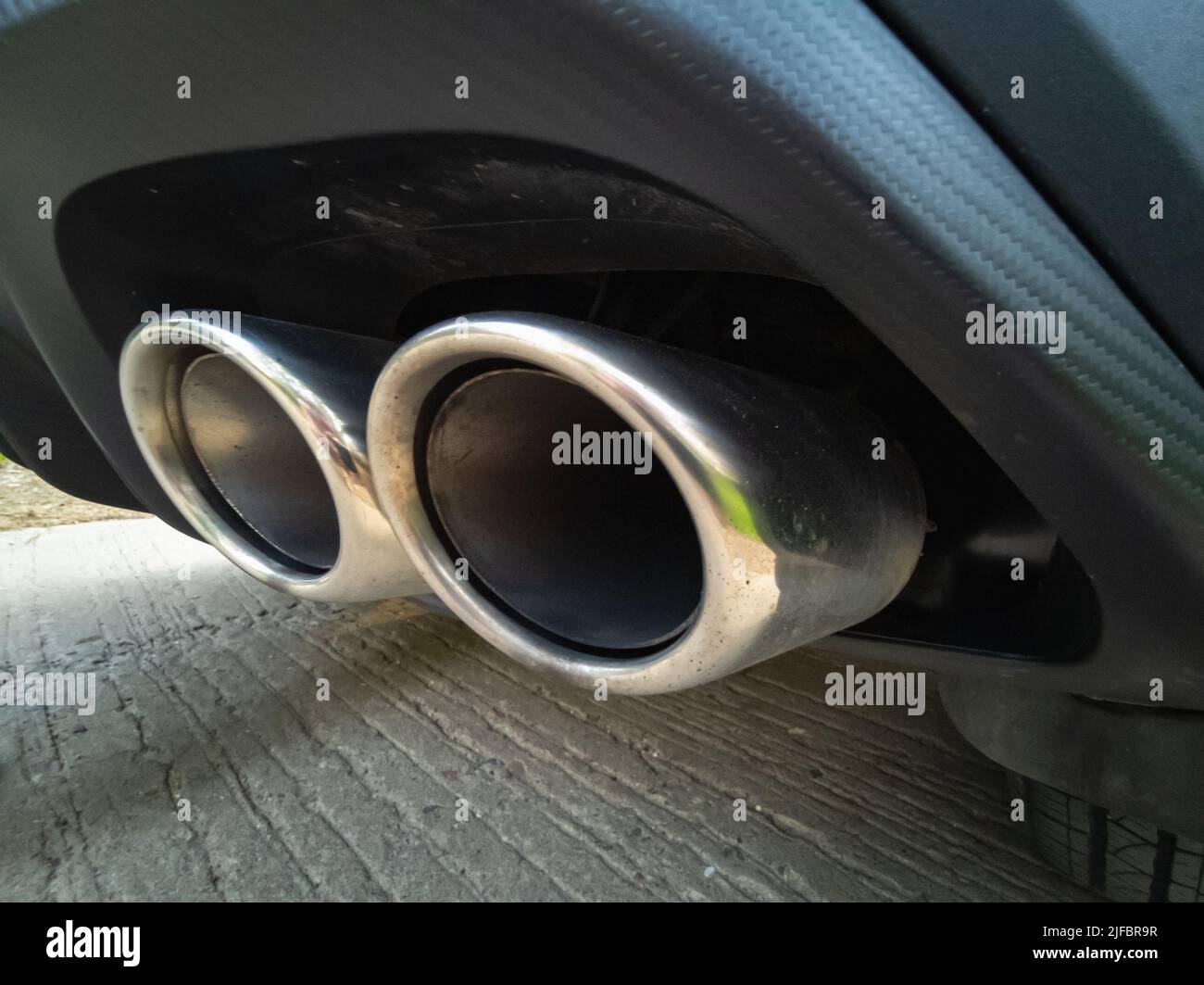 Pipes of the dual exhaust system of a car close-up Stock Photo - Alamy