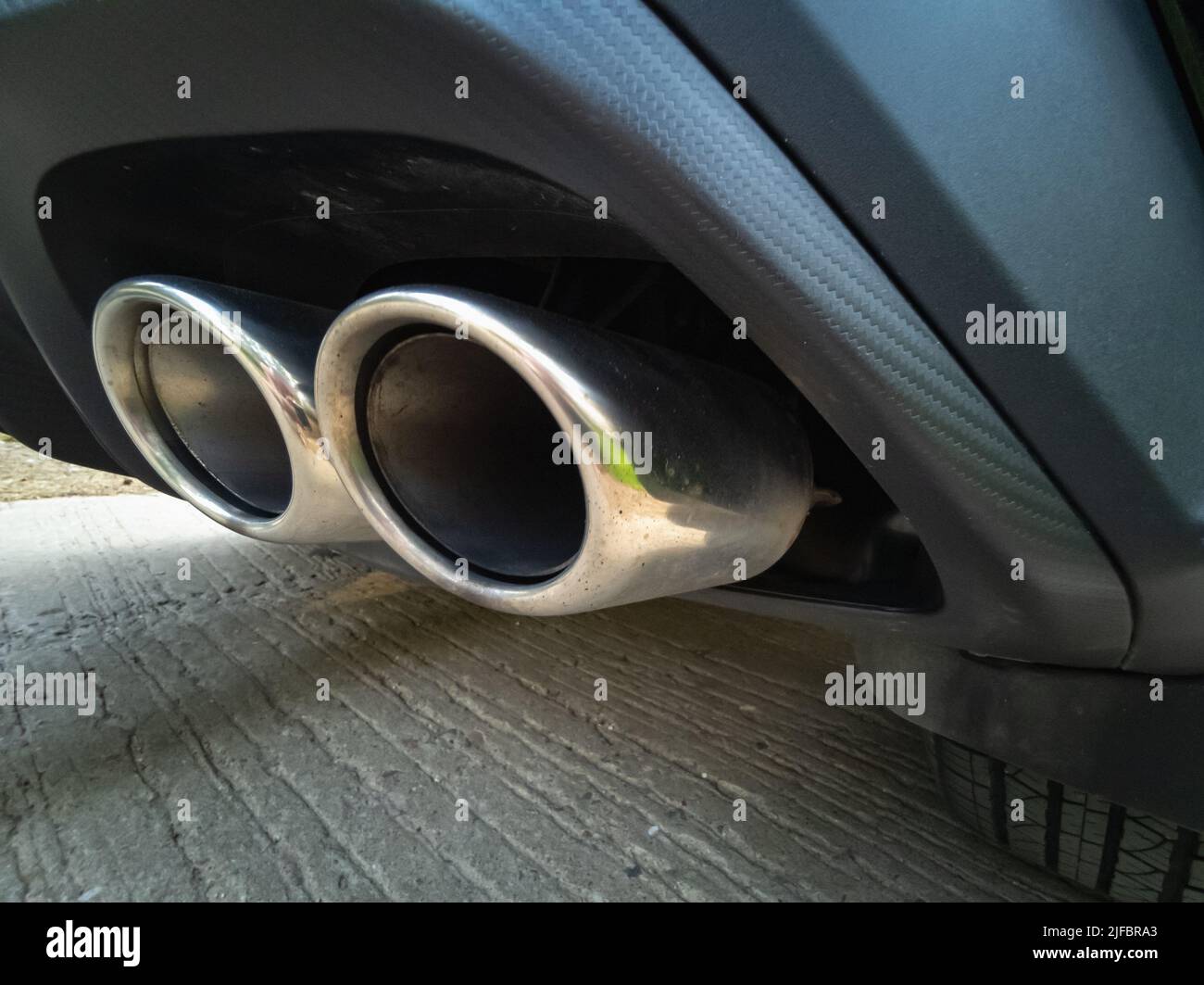 Pipes of the dual exhaust system of a car close-up Stock Photo - Alamy