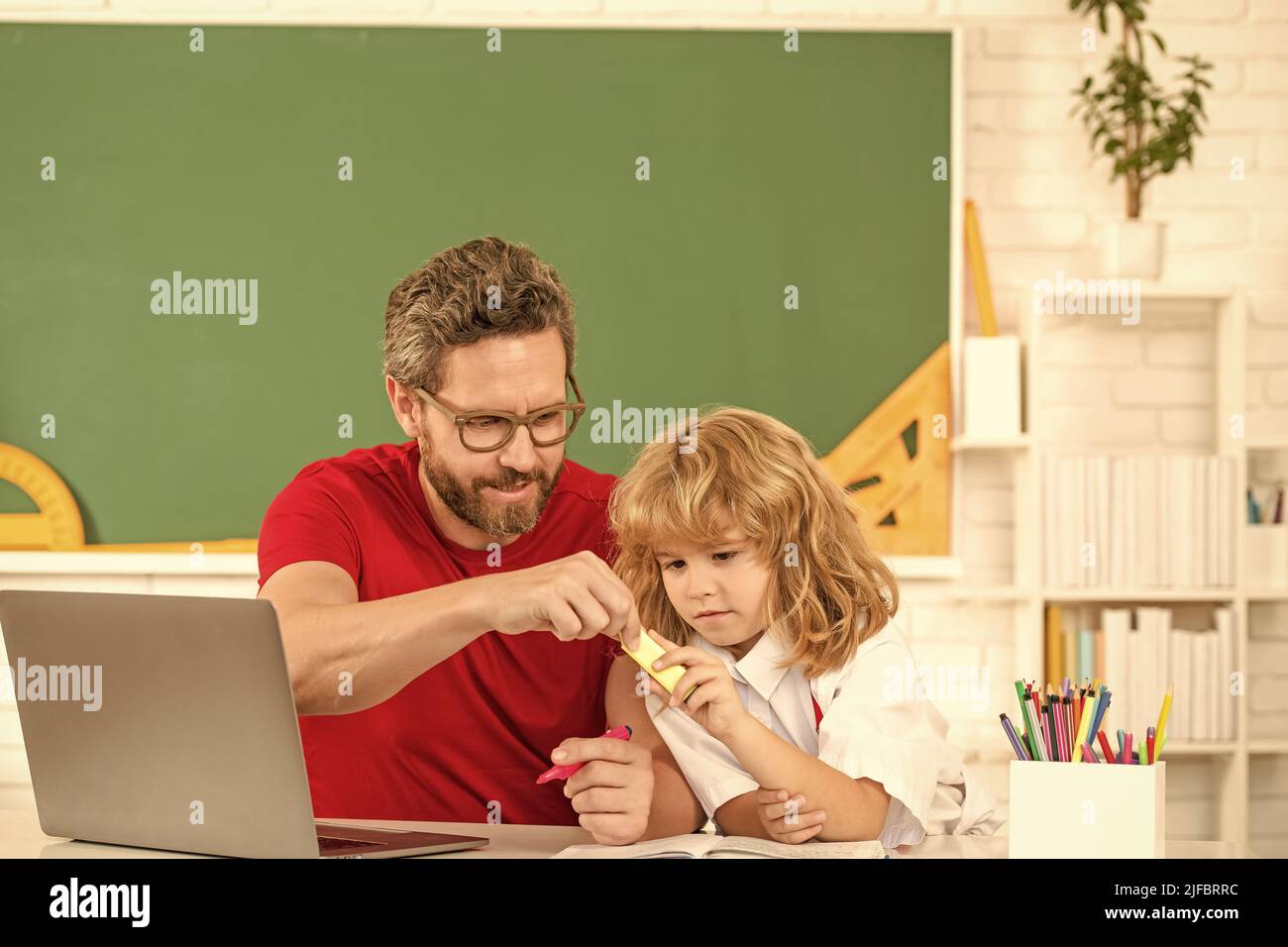 father and child study in classroom with laptop, knowledge Stock Photo ...