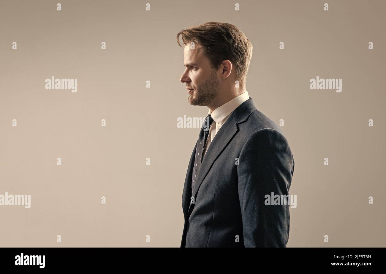 Treat him seriously. Serious guy stand sideway. Guy in formalwear grey ...