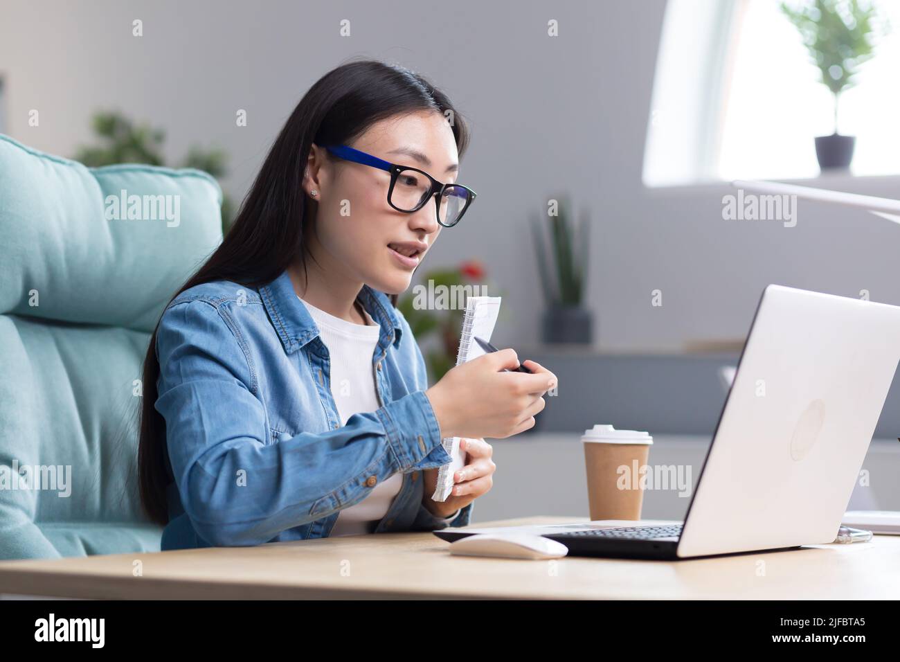 Young Asian business coach teacher teaches online, works in the office ...