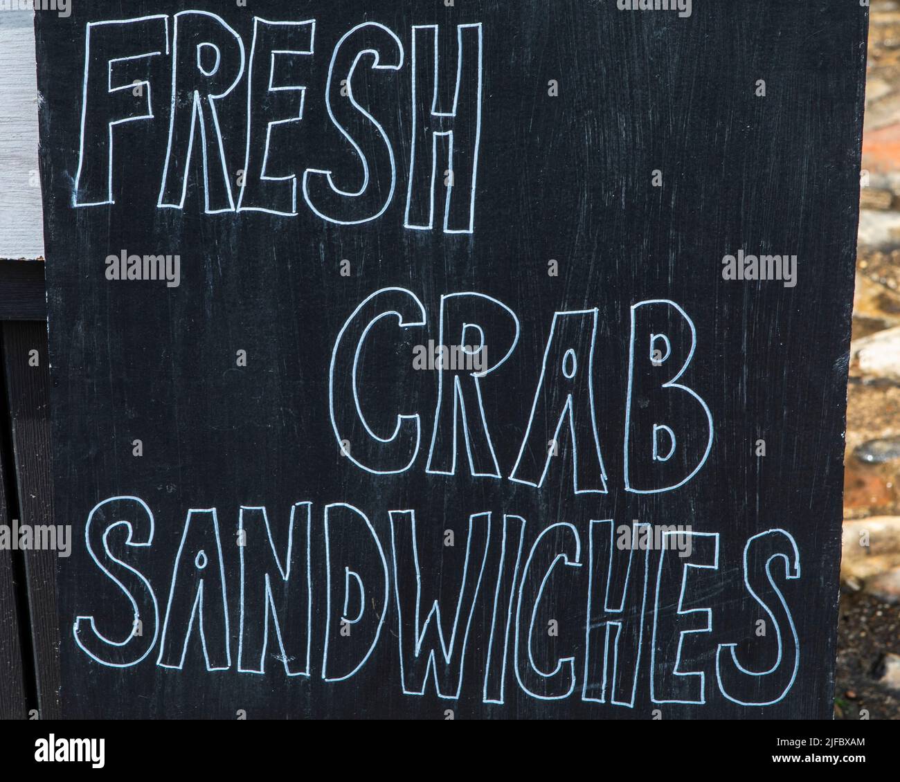 A sign advertising Fresh Crab Sandwiches on sale in the seaside town of ...