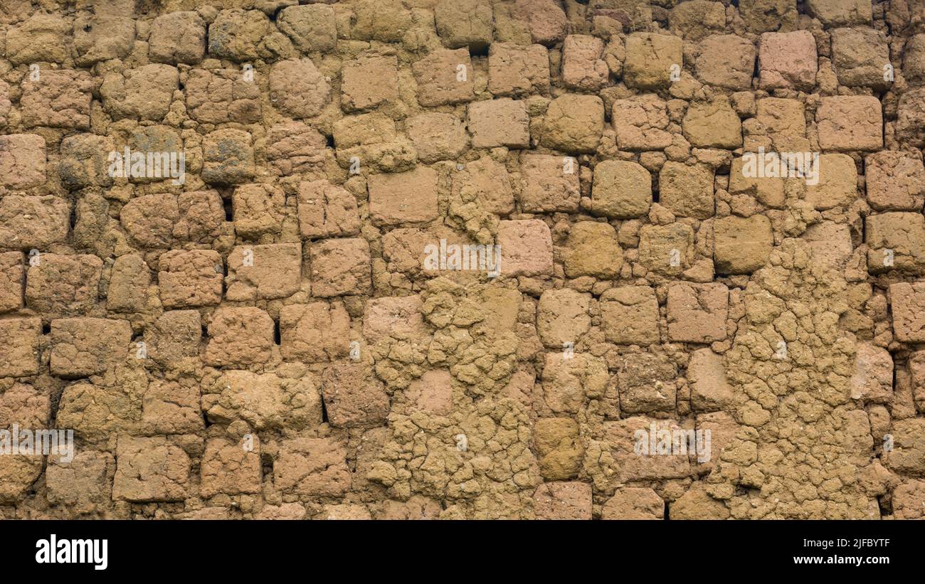 section of a old unbaked brick wall surface, also known as sun dried ...