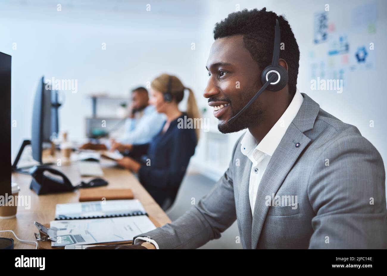 Happy young african american call centre telemarketing agent talking on ...