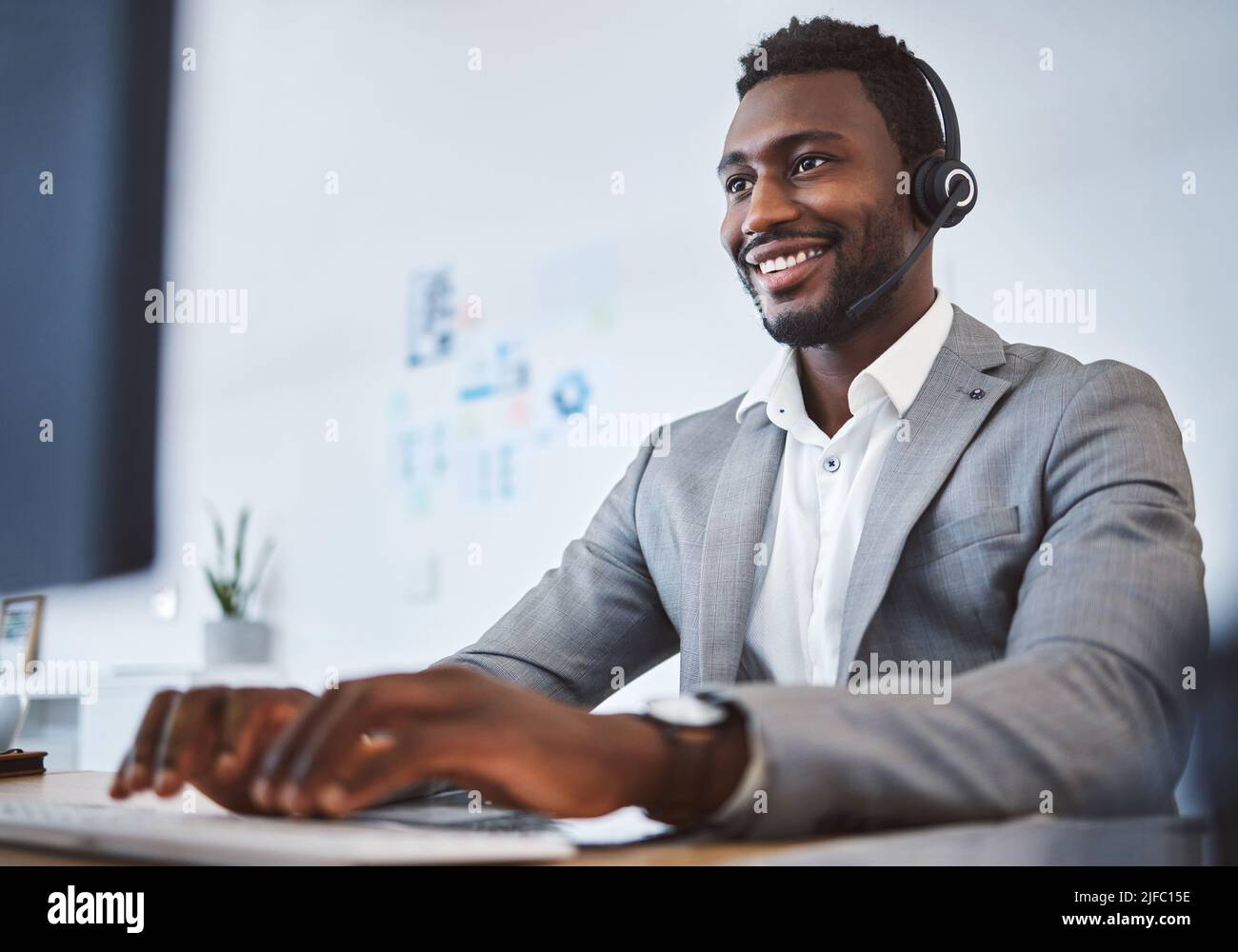 One happy young african american call centre telemarketing agent ...