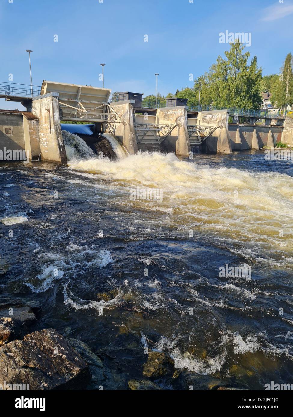 A vertical shot of Hydro Electric dam with a stream of water under the ...