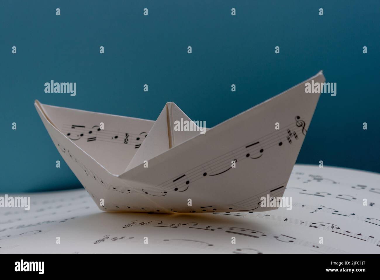 A closeup shot of a beautiful origami of a boat from the music notes ...