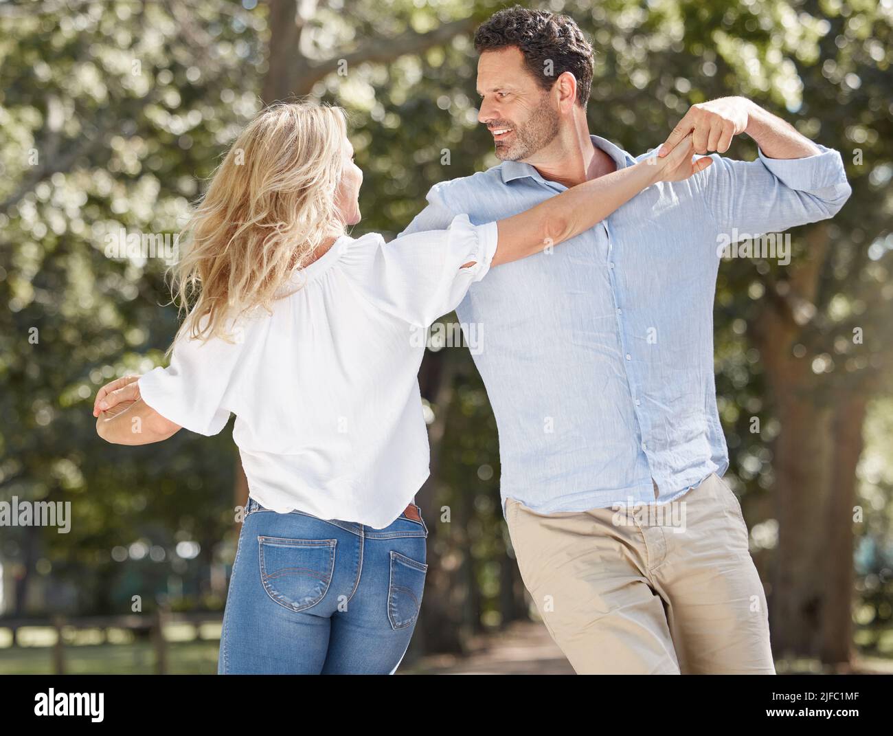 Loving young couple having romantic moment while sharing a dance and ...