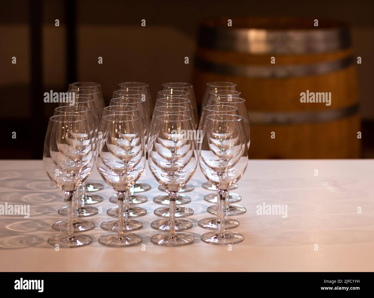 sparkling crystal wine glasses arranged in a row on a table with a ...