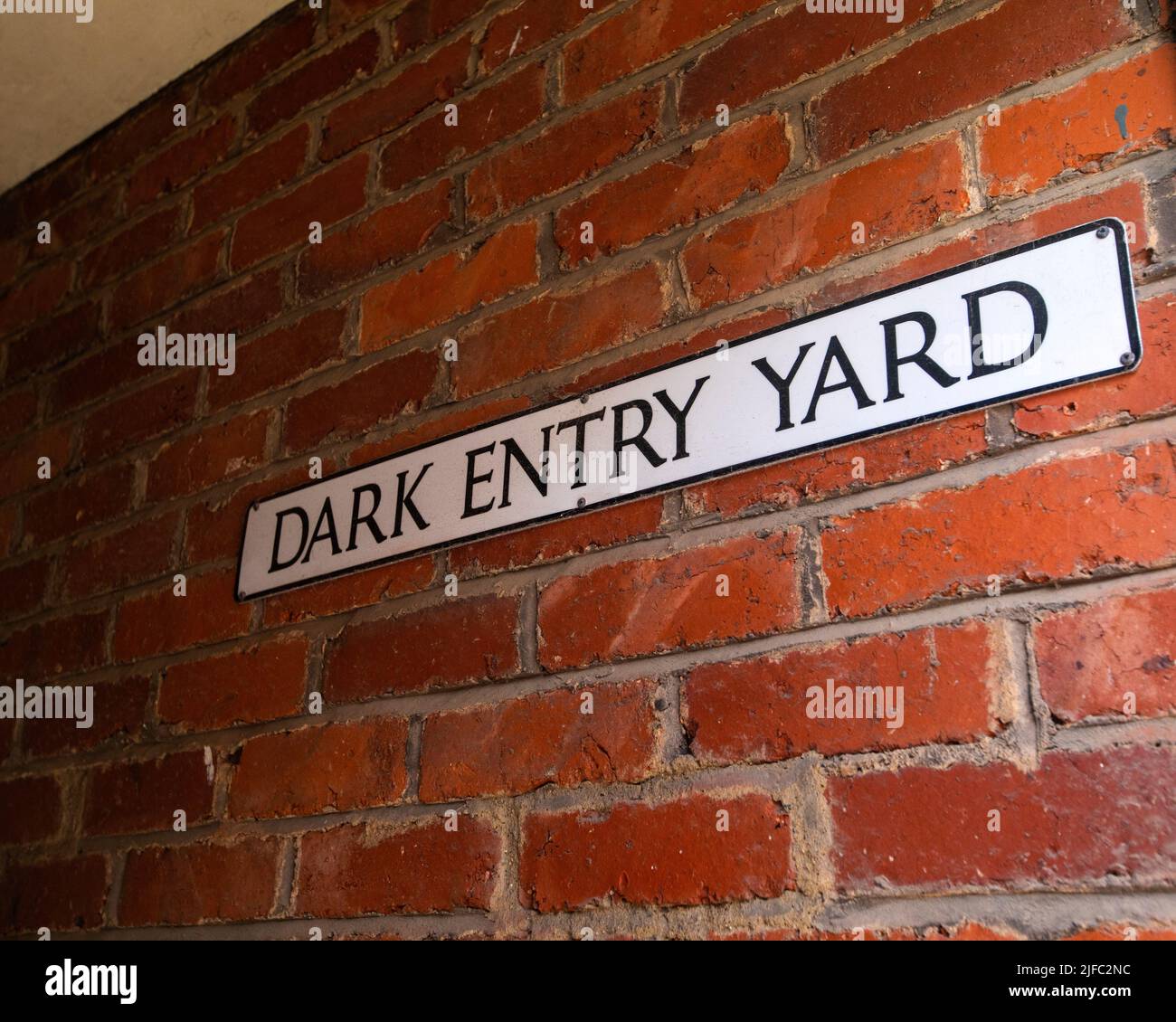Street sign for Dark Entry Yard in the seaside town of Whitby in North ...
