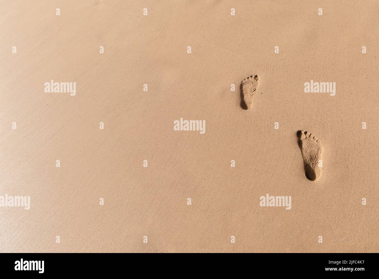 Two footsteps in the sand on a walk in Maui Hawaii Stock Photo - Alamy