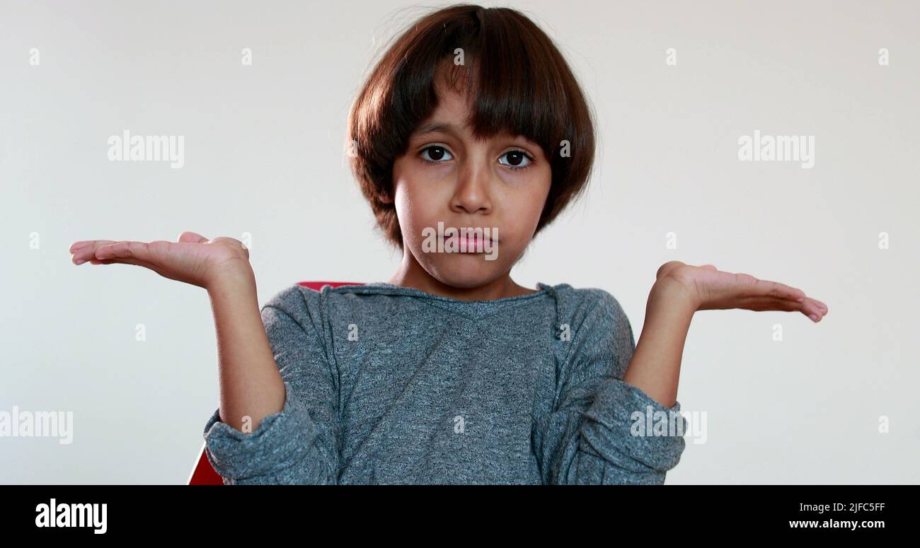 Doubtful young boy child kid. Ethnically diverse showing doubt Stock ...
