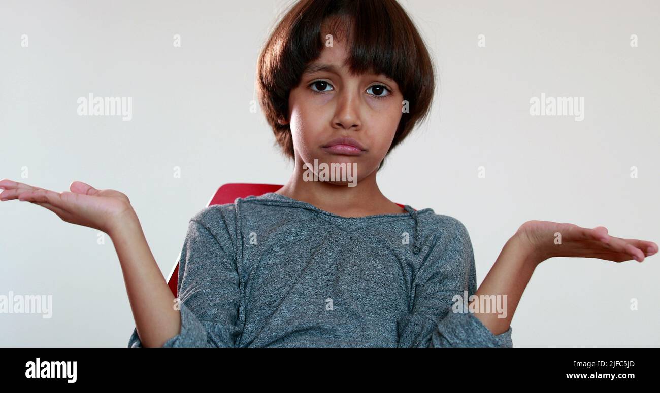 Doubtful young boy child kid. Ethnically diverse showing doubt Stock ...