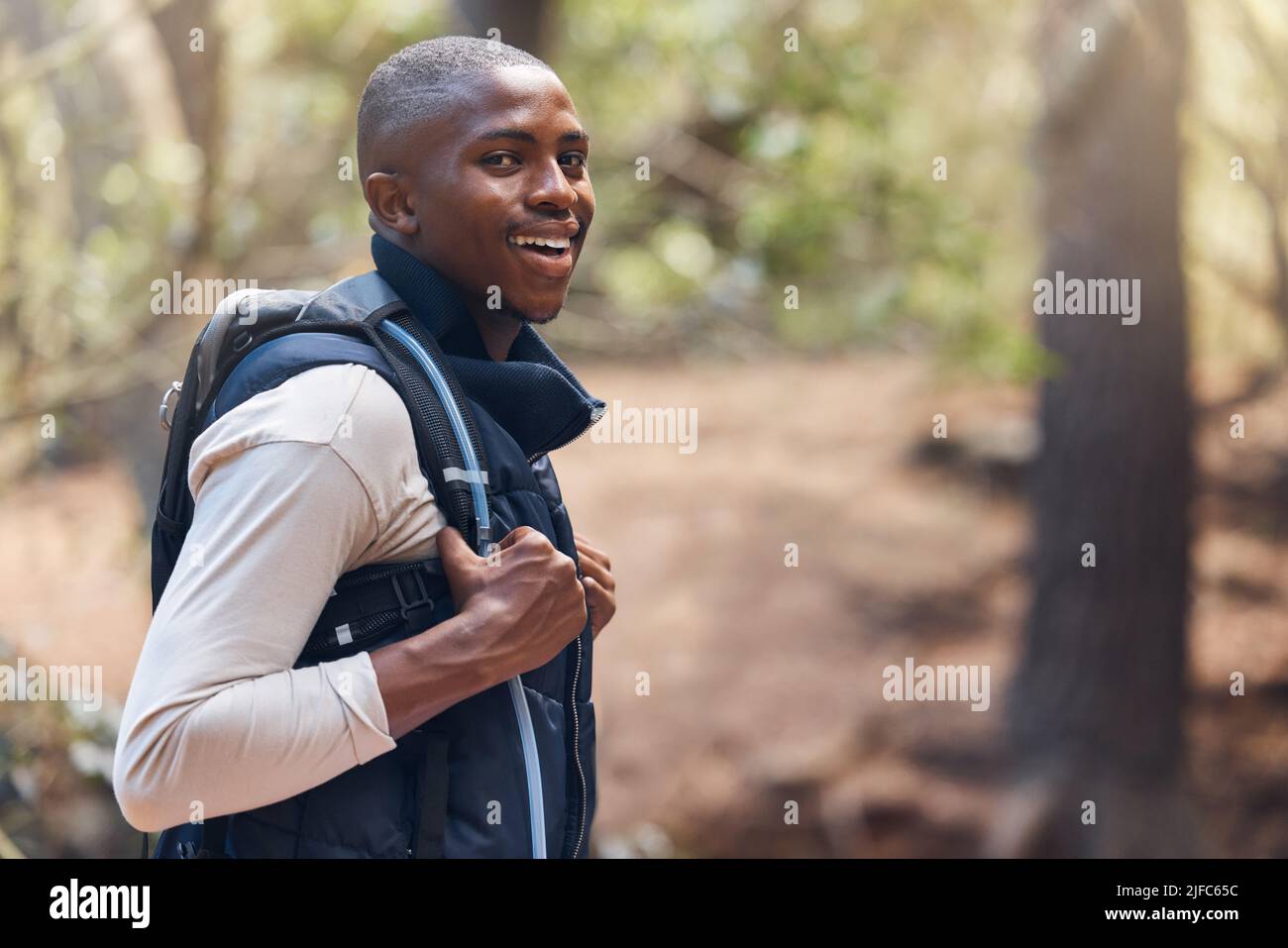 One young handsome african american male backpacker hiking outdoors in ...