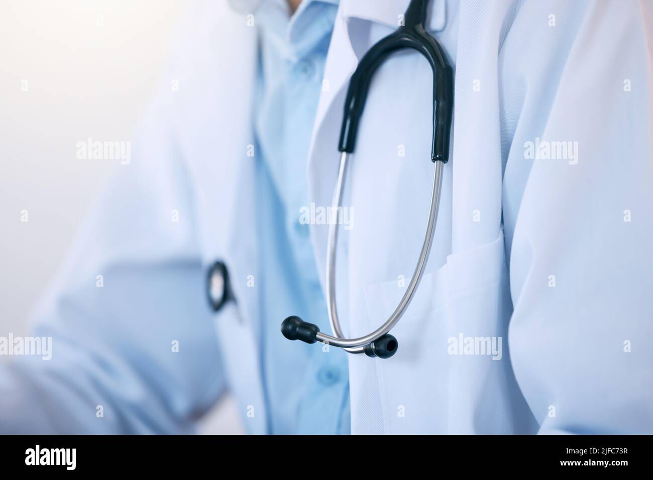 Closeup of one male doctor or cardiologist wearing a white lab coat ...