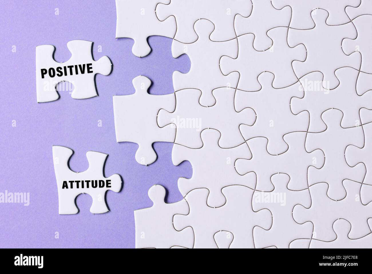 Positive attitude word on white jigsaw puzzle with some missing pieces ...