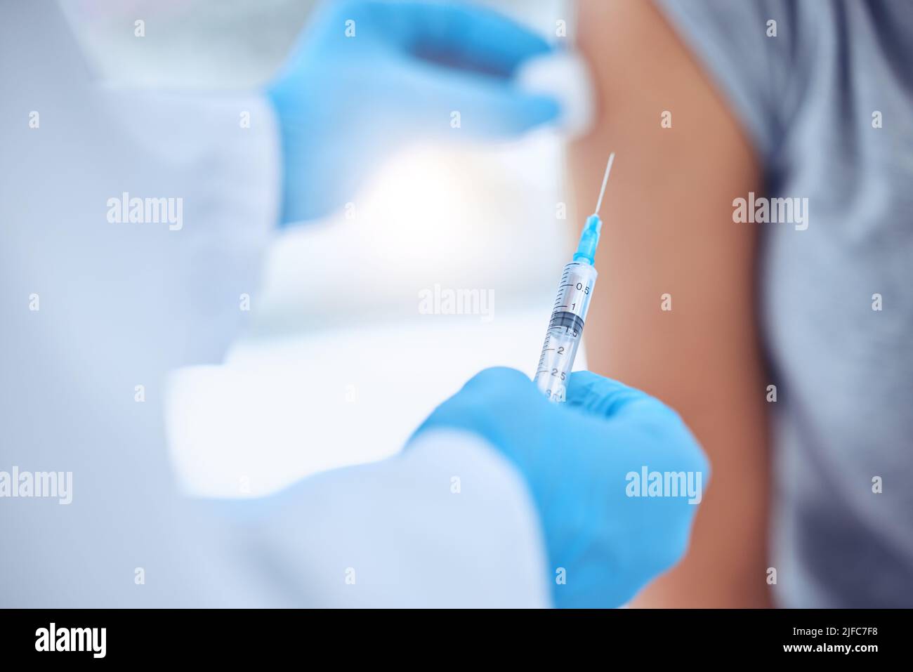 Doctor preparing a patient for injection. Caring doctor holding a ...