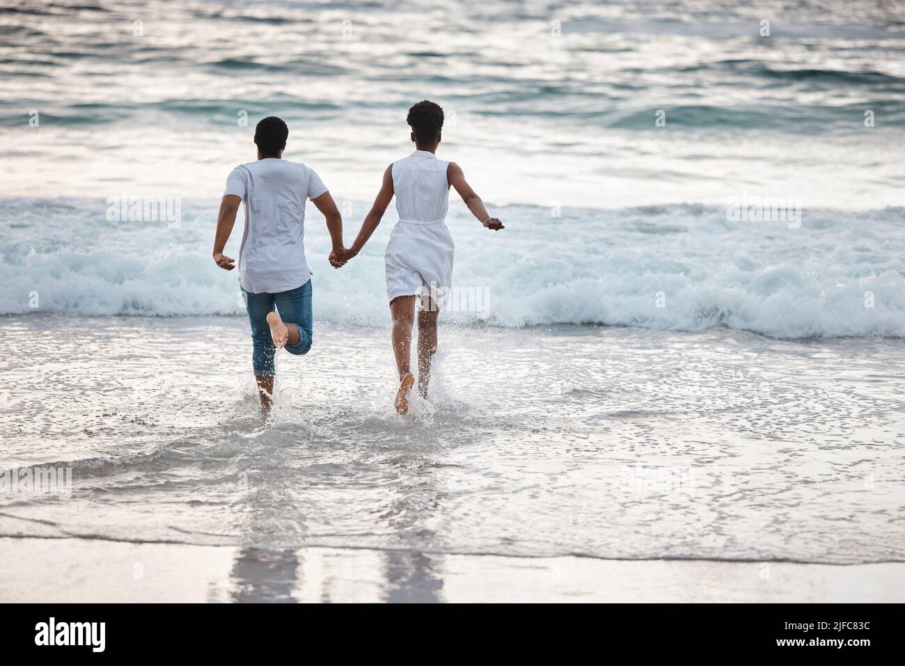 Happy african American couple spending a day at the sea together ...