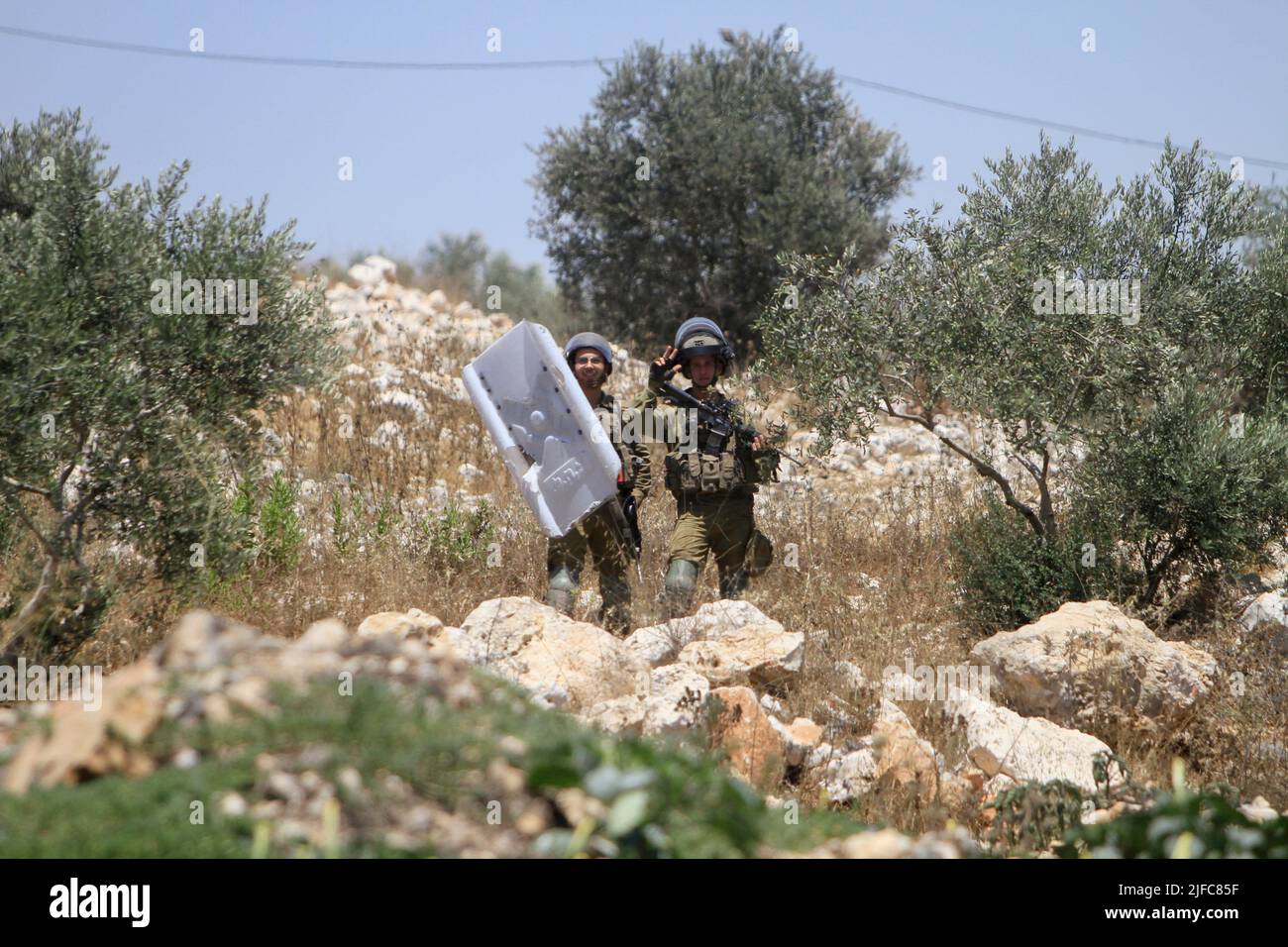 Nablus, Palestine. 01st July, 2022. Israeli soldiers take cover from ...