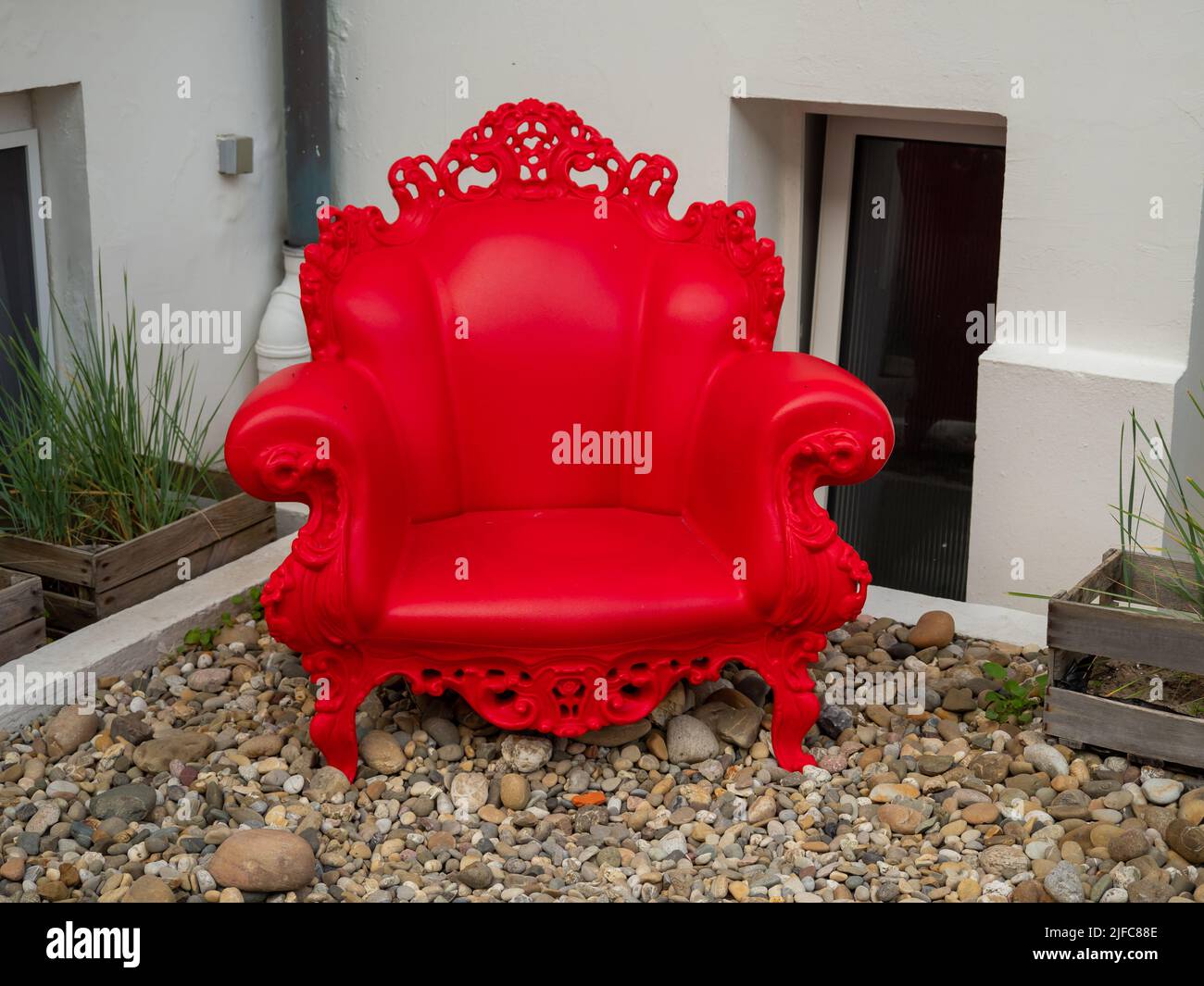 Red armchair at home. Red armchair against the wall of the house Stock ...