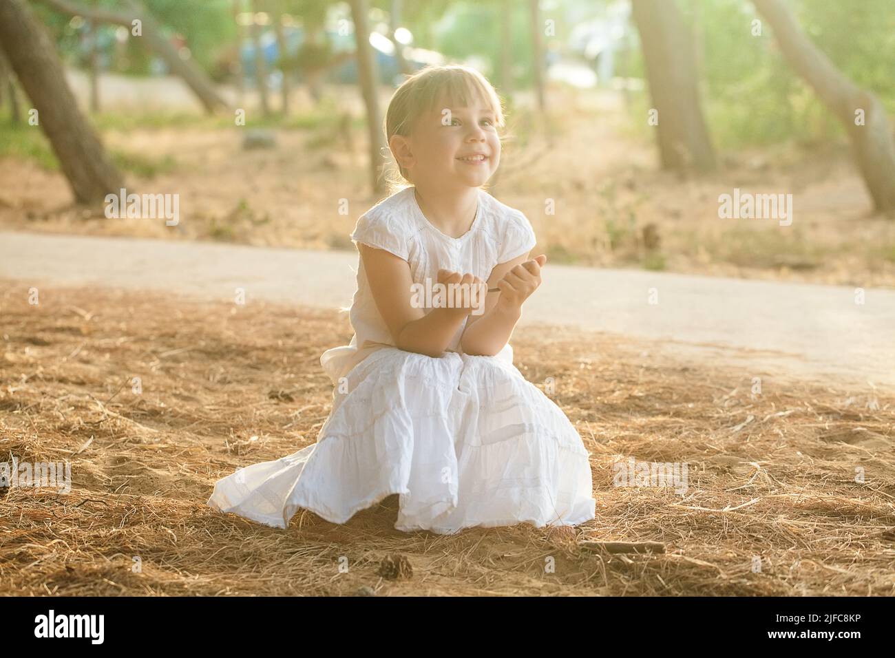Portrait of happy kid playing outdoors in summer sun light Stock Photo ...