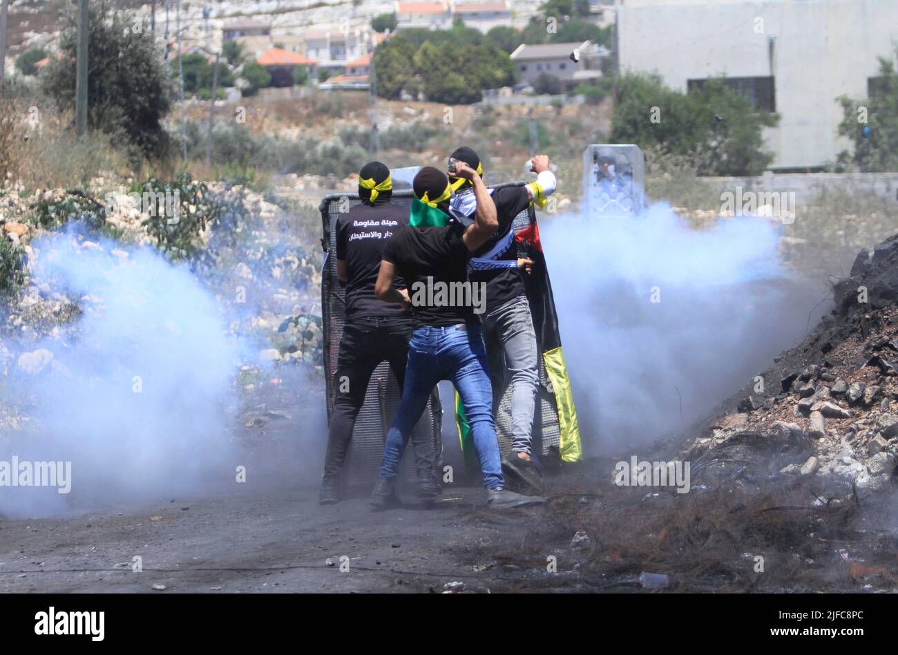 Palestinian protesters hurl stones at the Israeli soldiers while taking ...