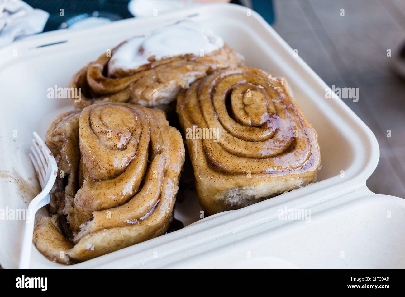 Fresh and hot large cinnamon rolls in a to go box from a bakery Stock ...