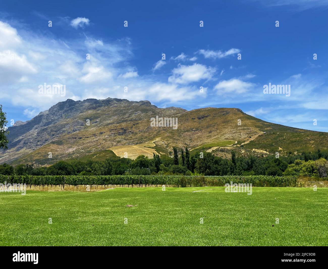 Mountain and valley with flat field in front Stock Photo - Alamy