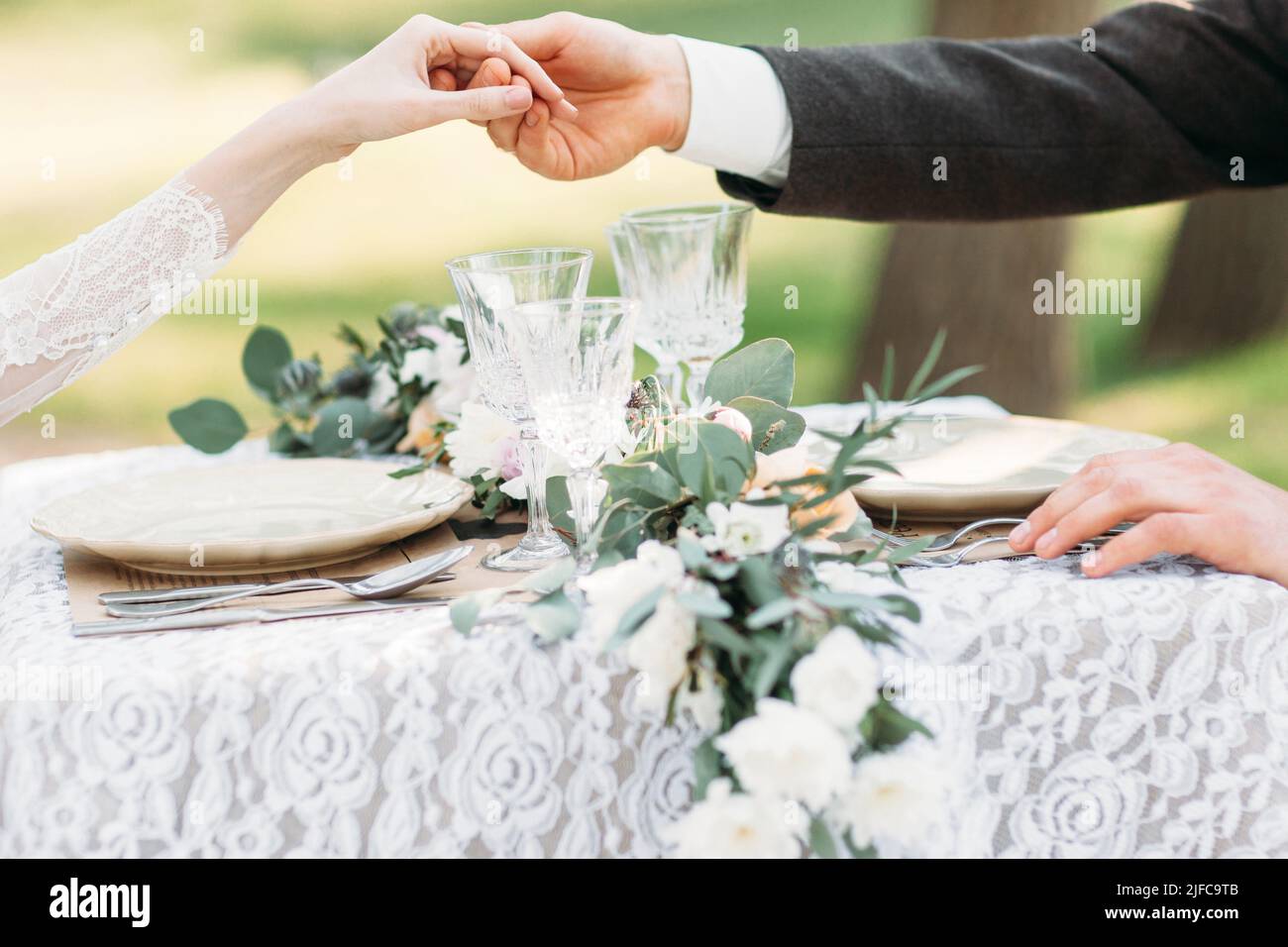 Couple holding hands dinner table hi-res stock photography and images ...