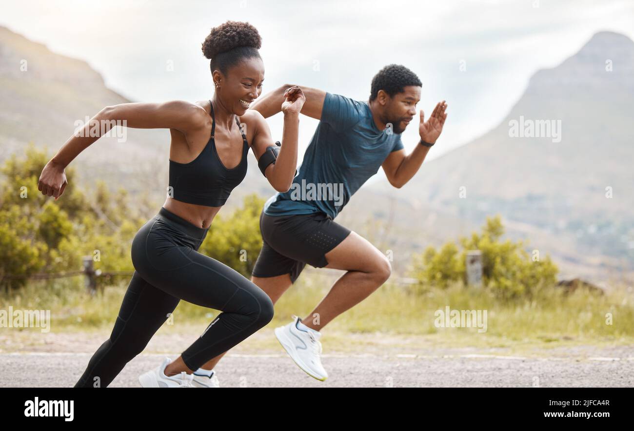 Fit african american couple running outdoors while exercising. Young ...