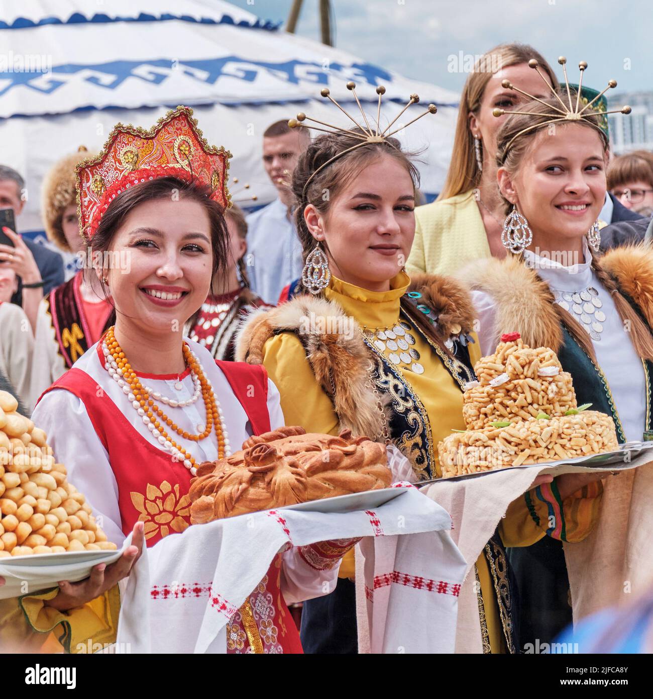 Bashkir and Russian girls in national festive clothes holding ...