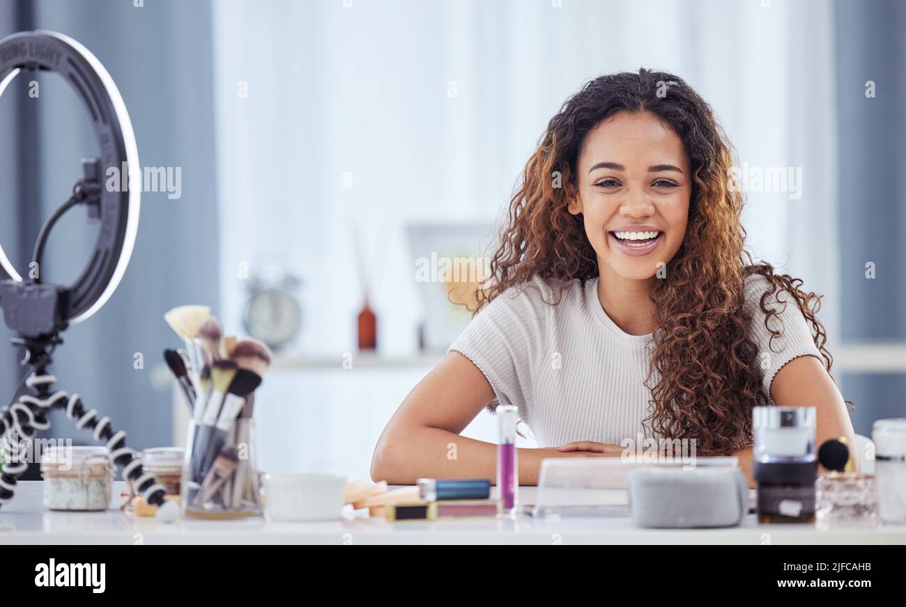 One hispanic woman recording a makeup tutorial for her beauty blog with ...