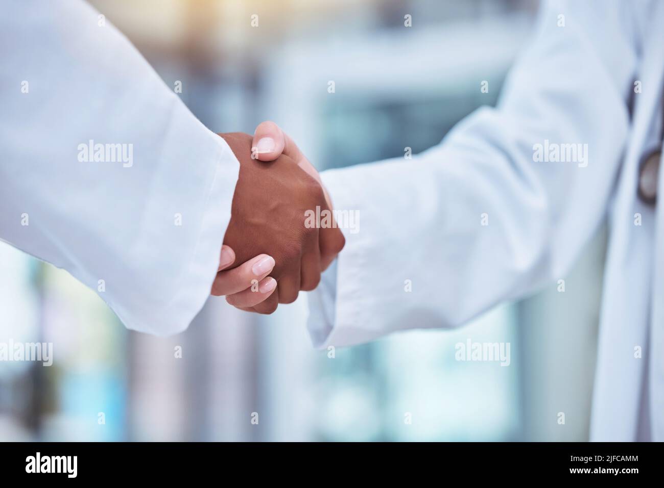 closeup of two doctors greeting and shaking hands in a meeting. Medical ...