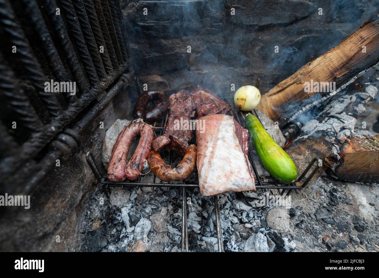 Typical Uruguayan and Argentine Asado Cooked on fire. Entrana and Vacio ...