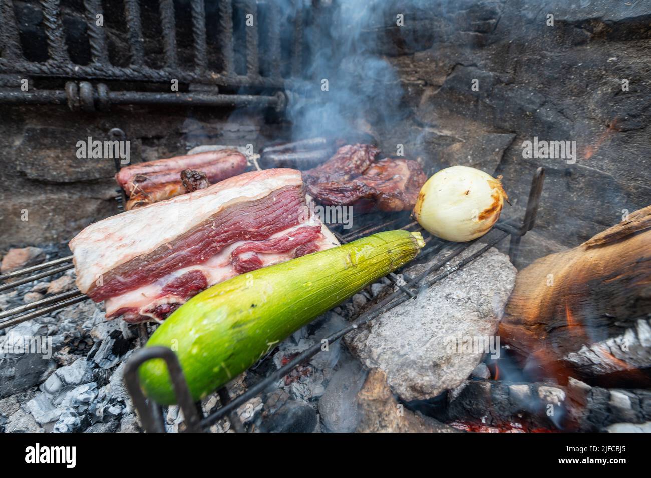 Typical Uruguayan and Argentine Asado Cooked on fire. Entrana and Vacio ...