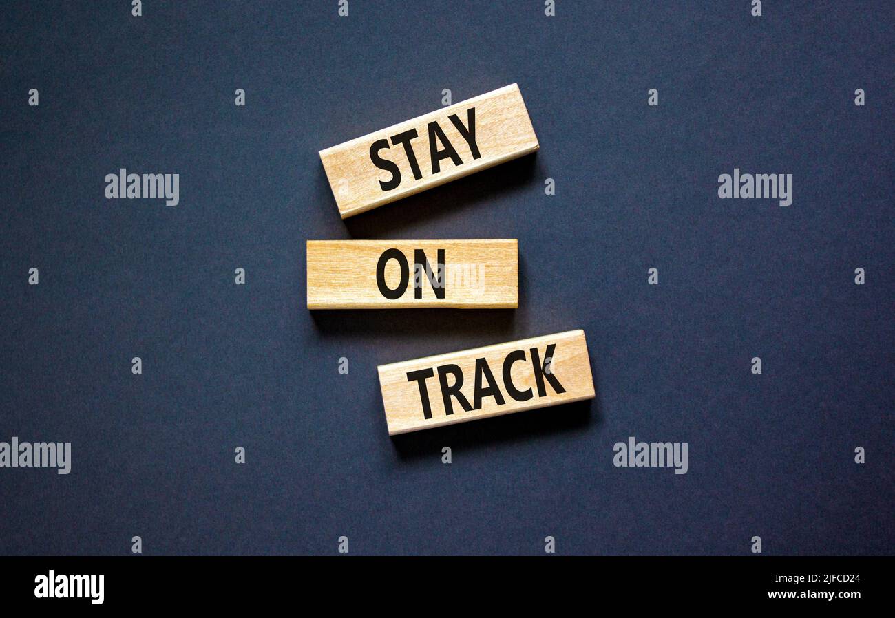Stay on track symbol. Concept words Stay on track on wooden blocks on a ...